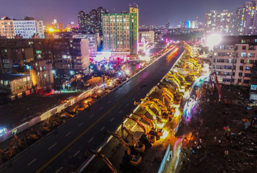 Amazing footage shows hundreds of diggers remove flyover in single night