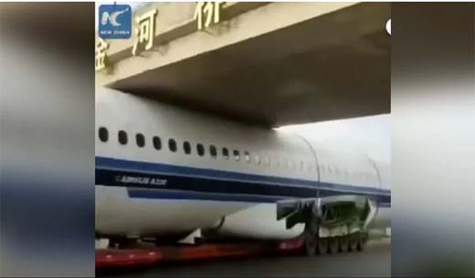 Airplane gets stuck under bridge in bizarre video
