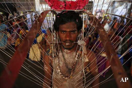 Devotees pierce their bodies during Lord Muruga festival