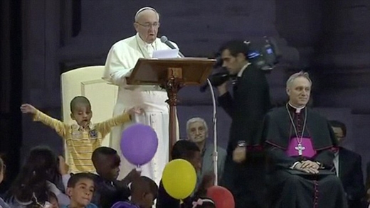Little boy sits in popes chair, steals the show