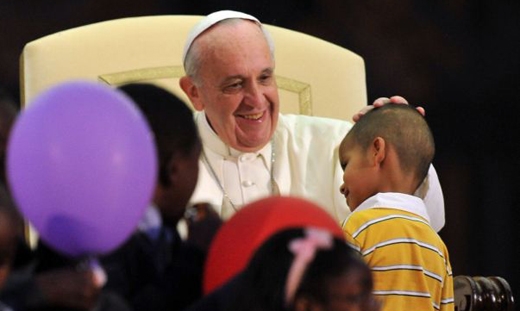 Little boy sits in popes chair, steals the show